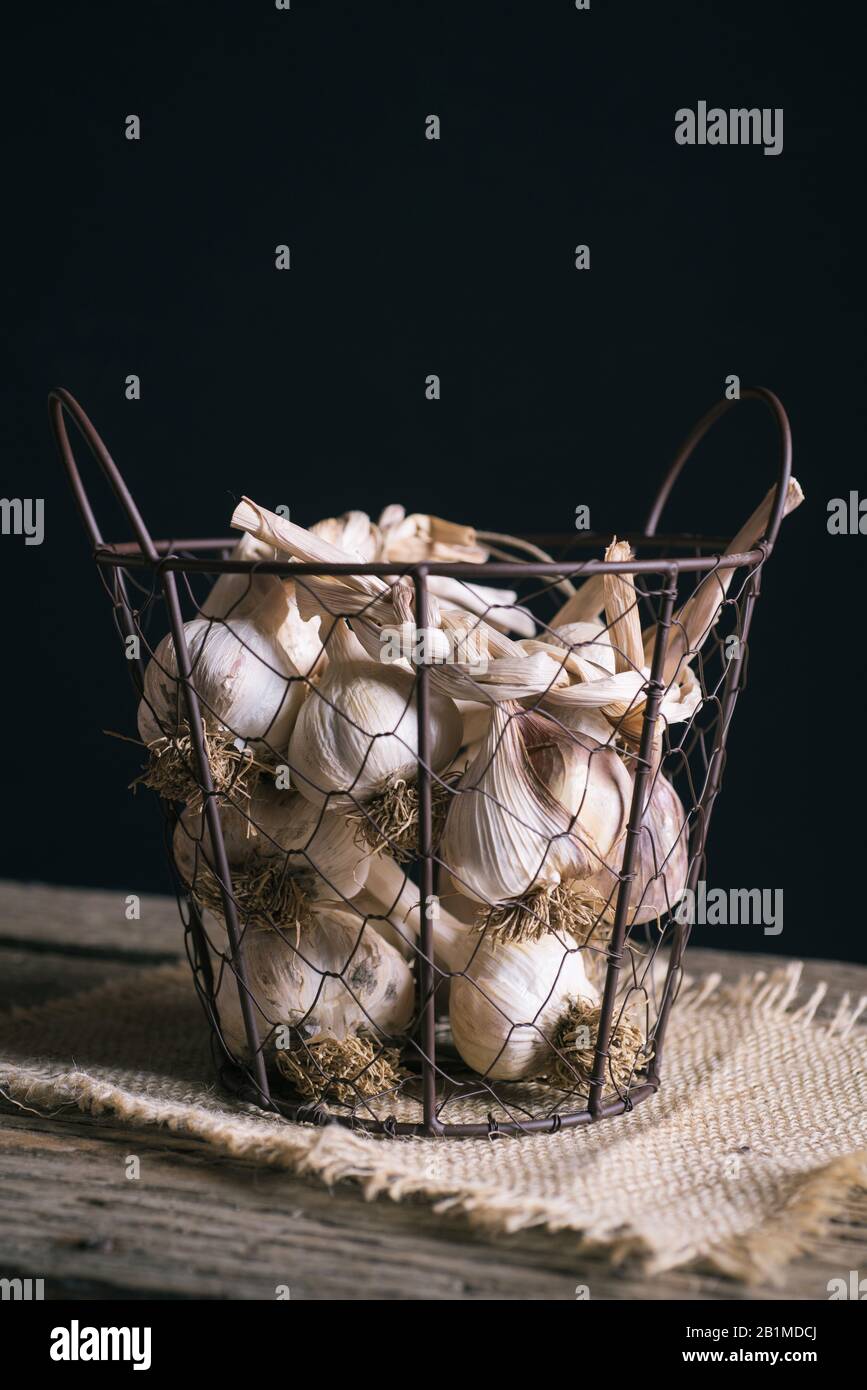 Garlic rope on dark background Stock Photo - Alamy