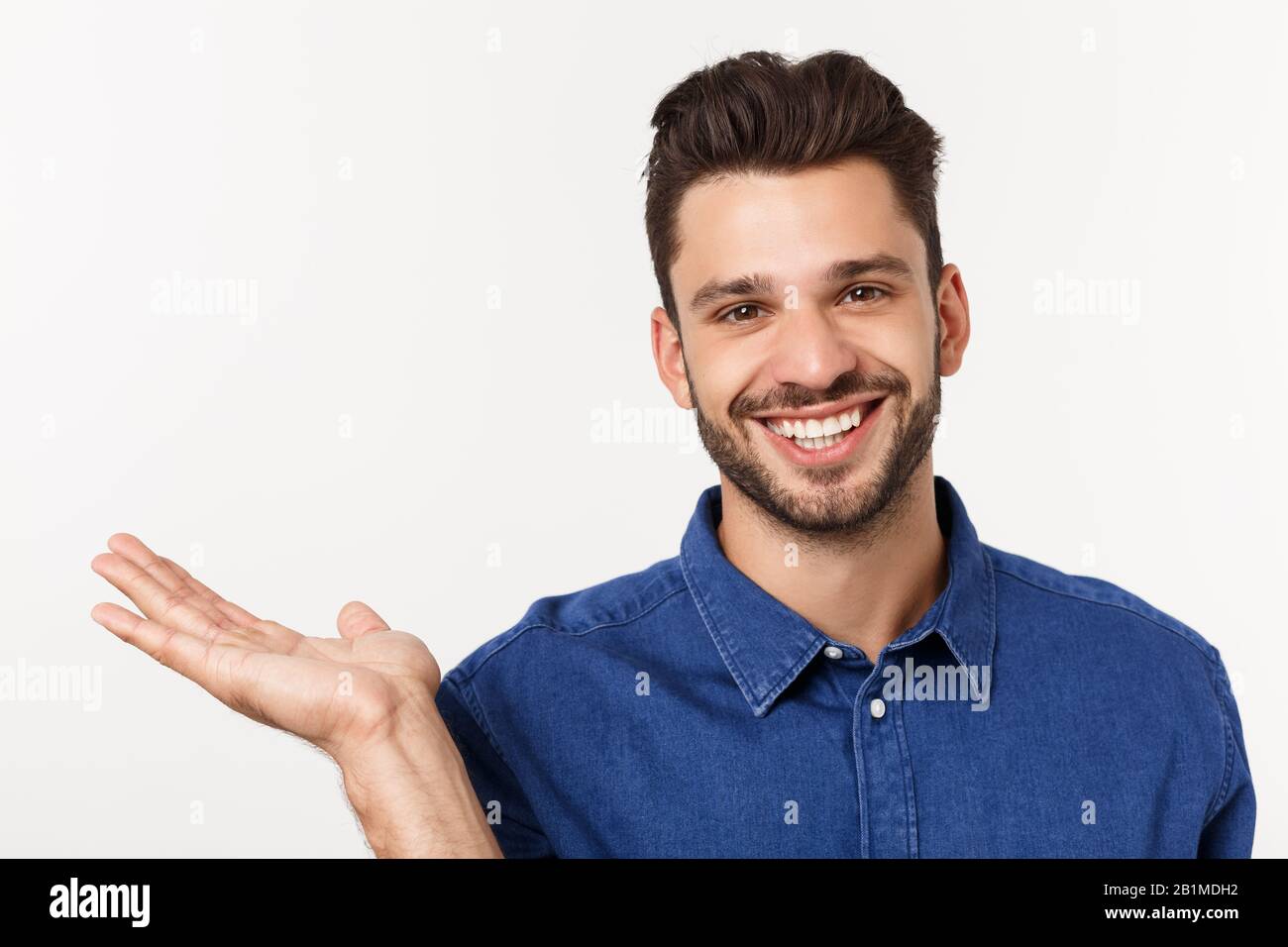 Charming handsome. Handsome young man in casual wear while standing ...