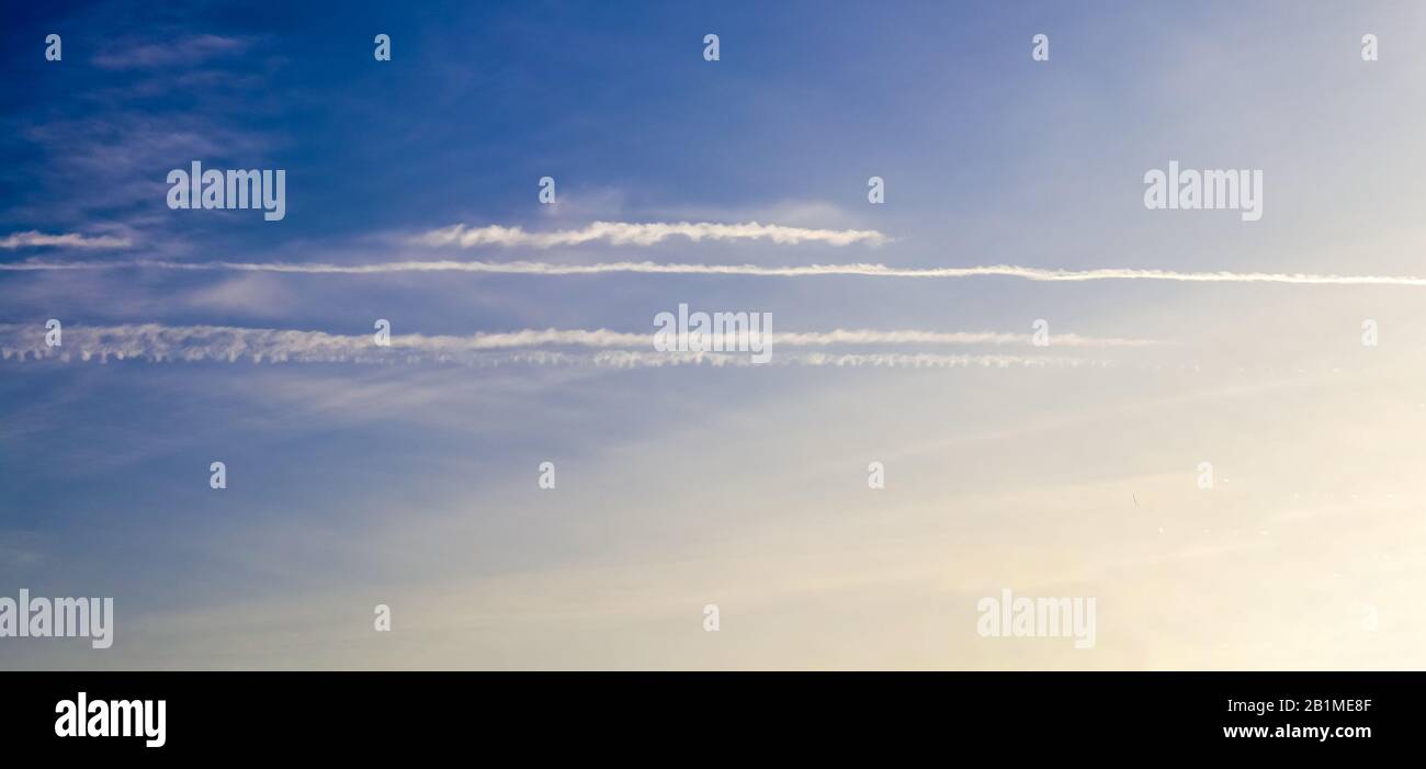 Beautiful aircraft vapor trails in a blue sky Stock Photo - Alamy