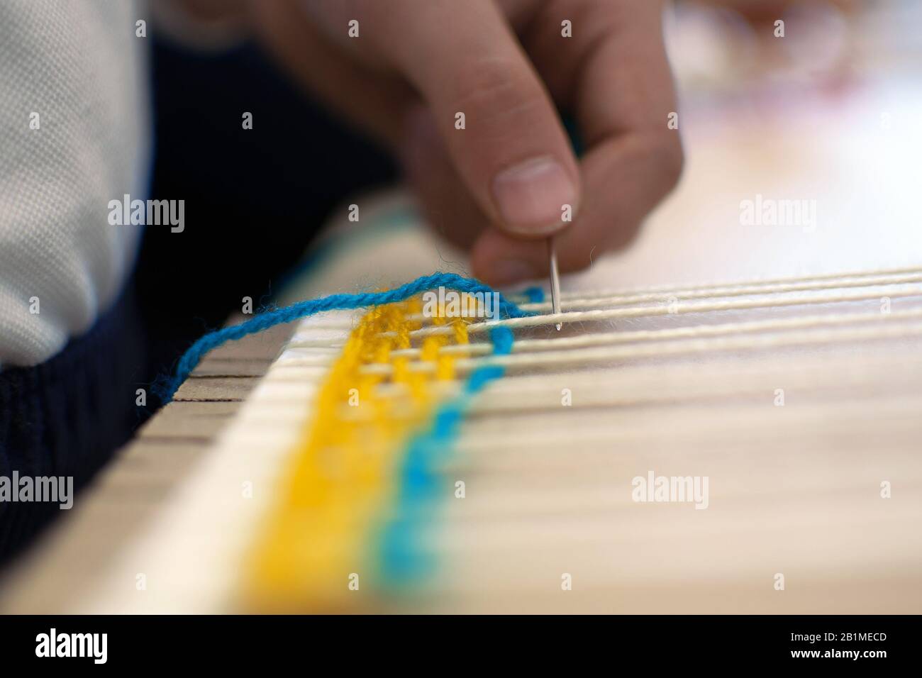 Little children hands weaving loom in art theraphy class at school ...
