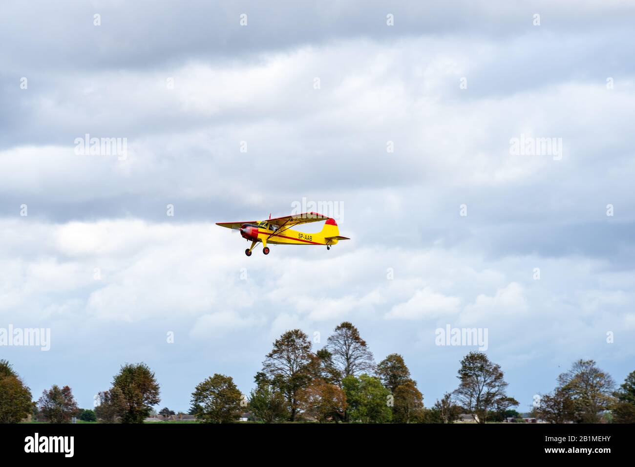 Small single engine airplane flying in the english cloudy sky Stock ...