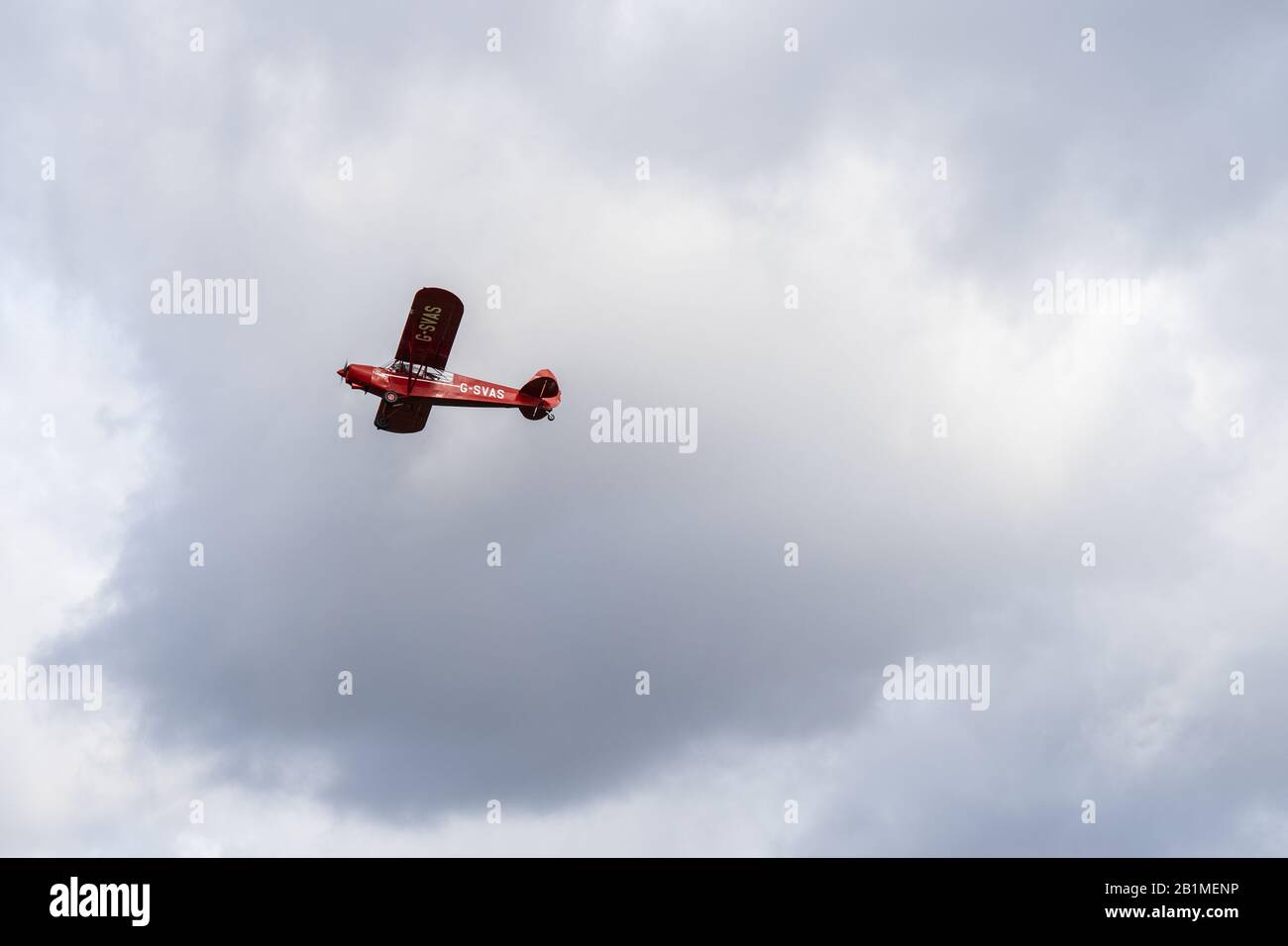 Small single engine airplane flying in the english cloudy sky Stock ...