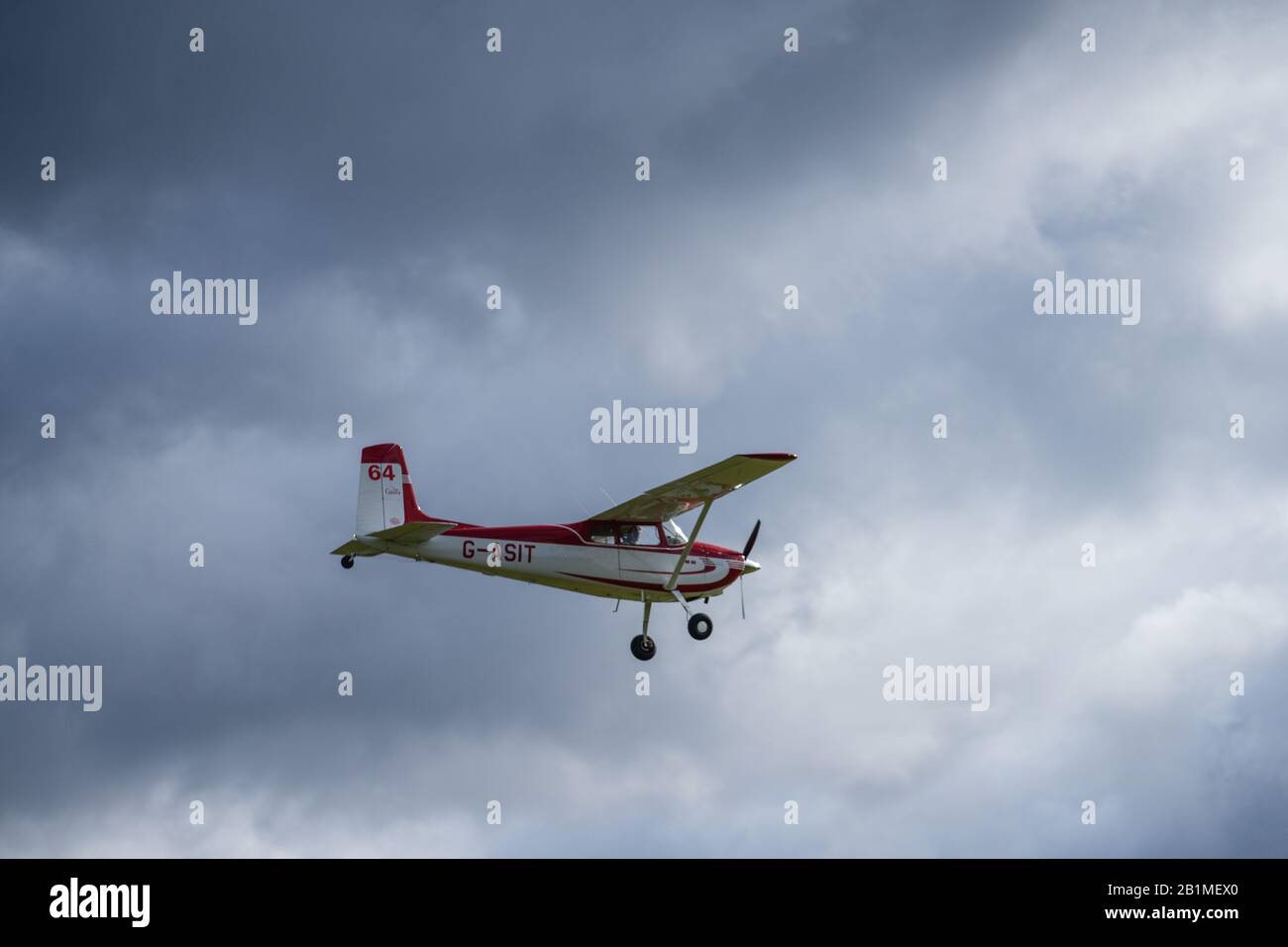 Small single engine airplane flying in the english cloudy sky Stock ...
