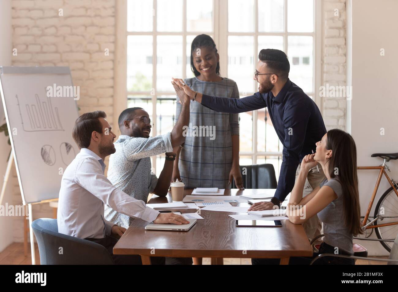 African and arab colleagues giving high five during group meeting Stock ...