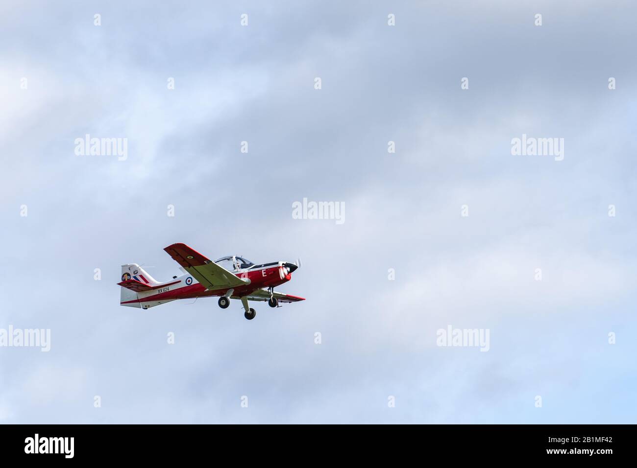Small single engine airplane flying in the english cloudy sky Stock ...