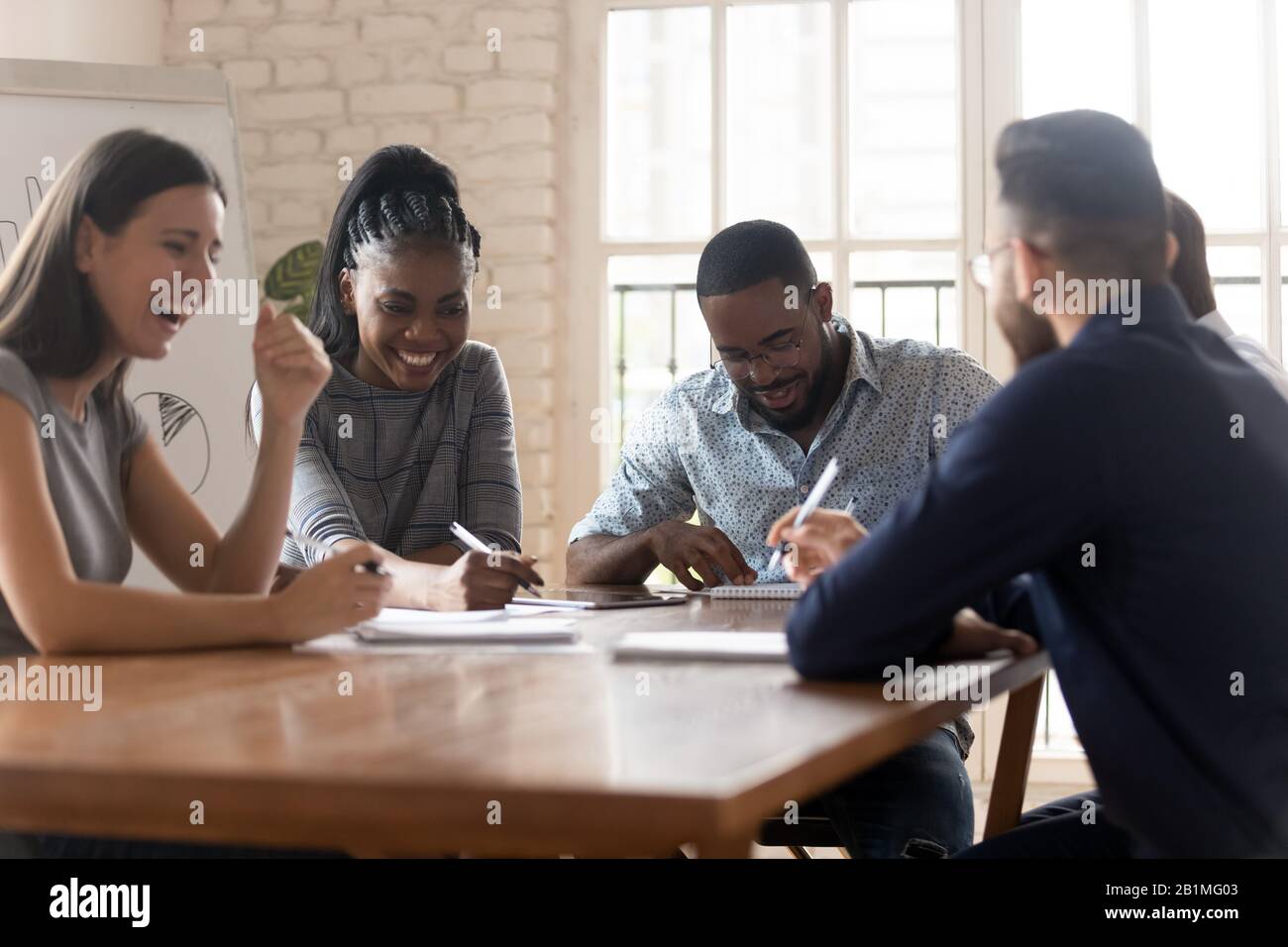 Employees take break during meeting having fun telling jokes laughing ...