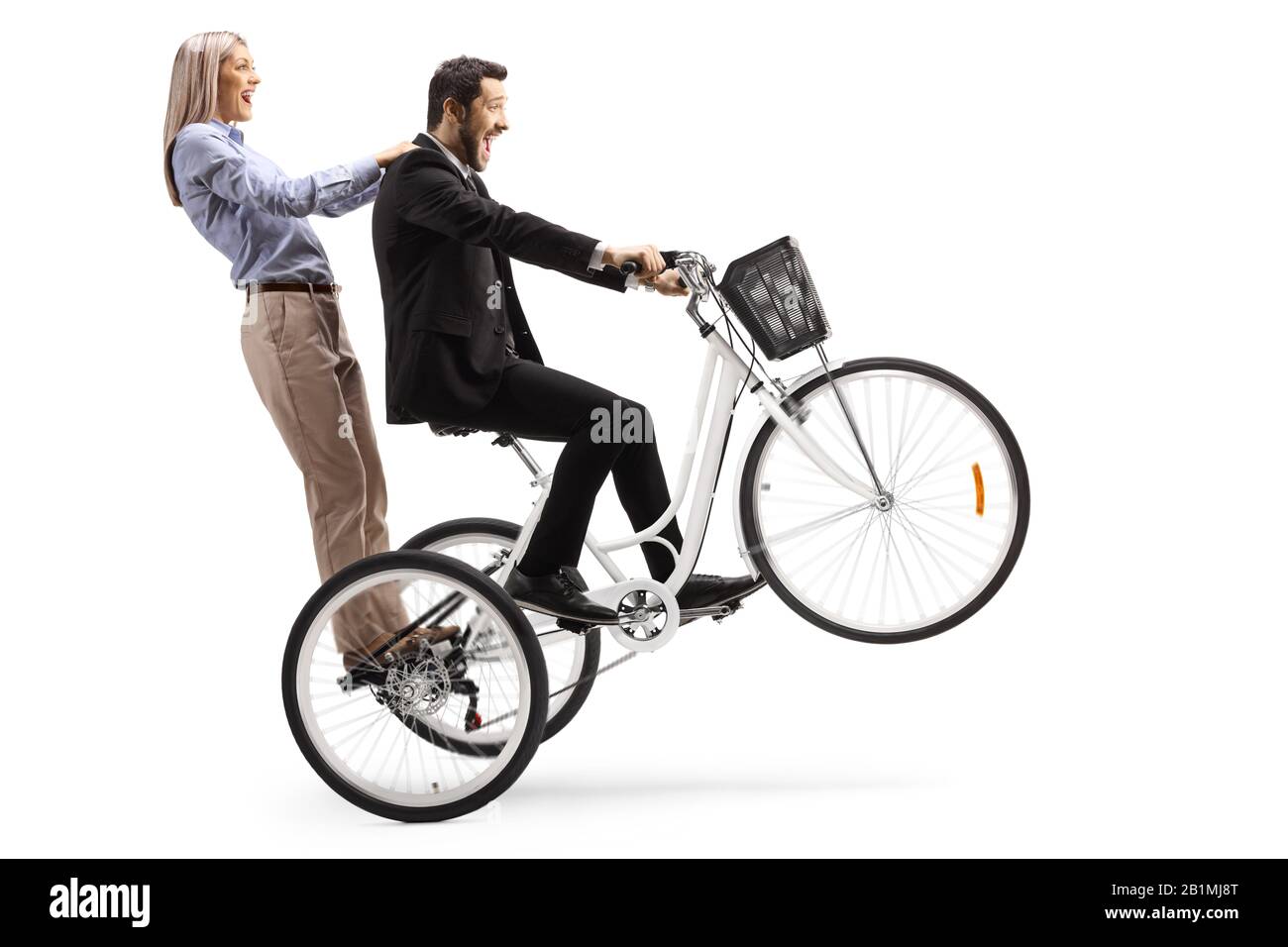 Man riding a woman on a tricycle with front wheel up isolated on white ...