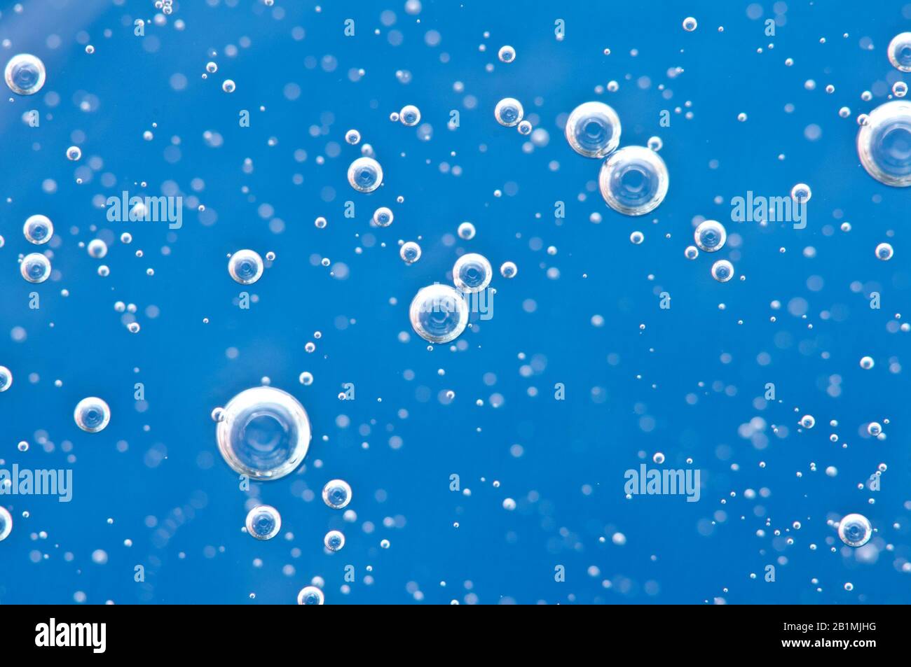 Bubbles of oxygen surging upward in blue water. Concept ecology ...