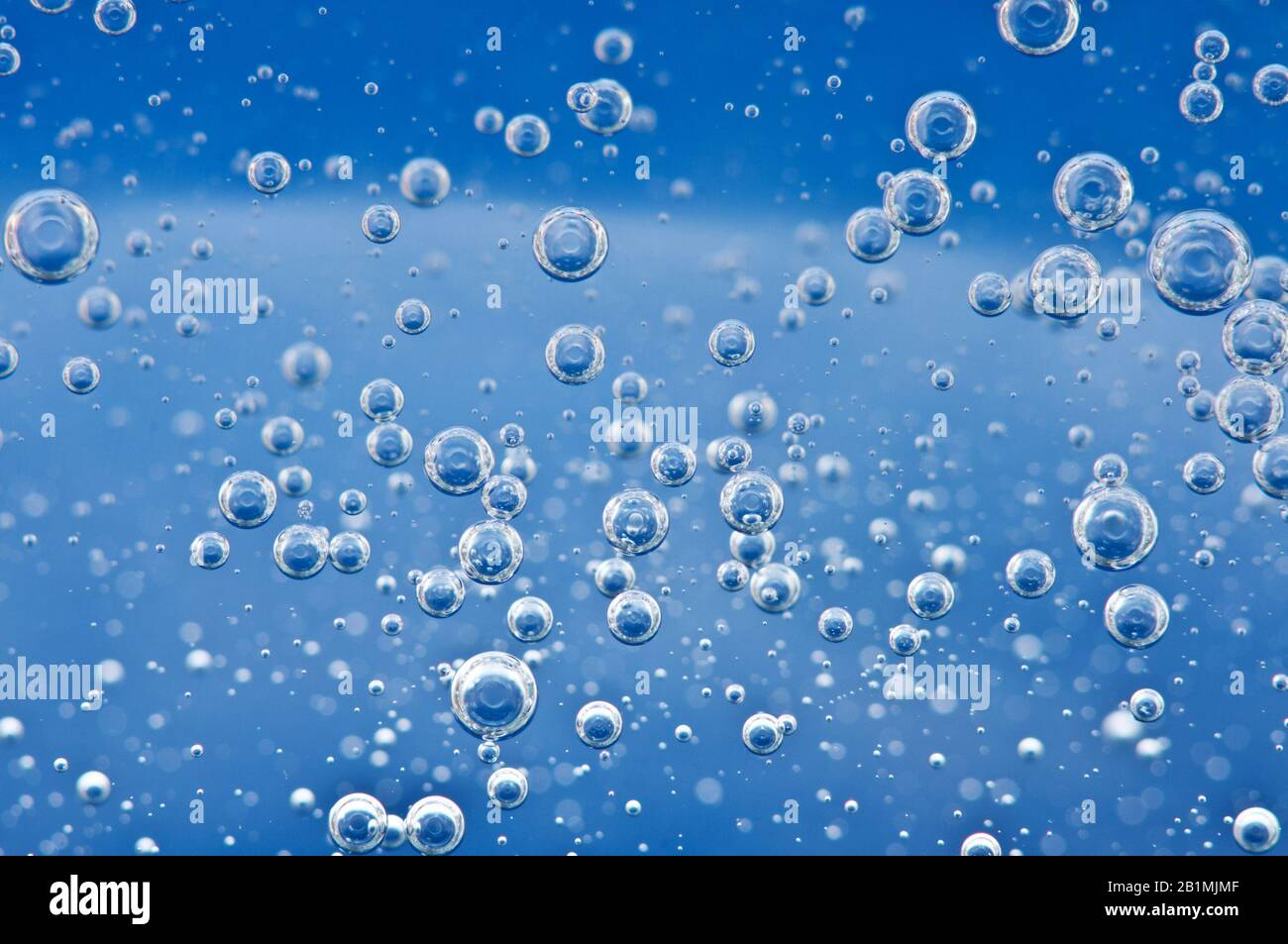 Bubbles of oxygen surging upward in blue water. Concept ecology ...