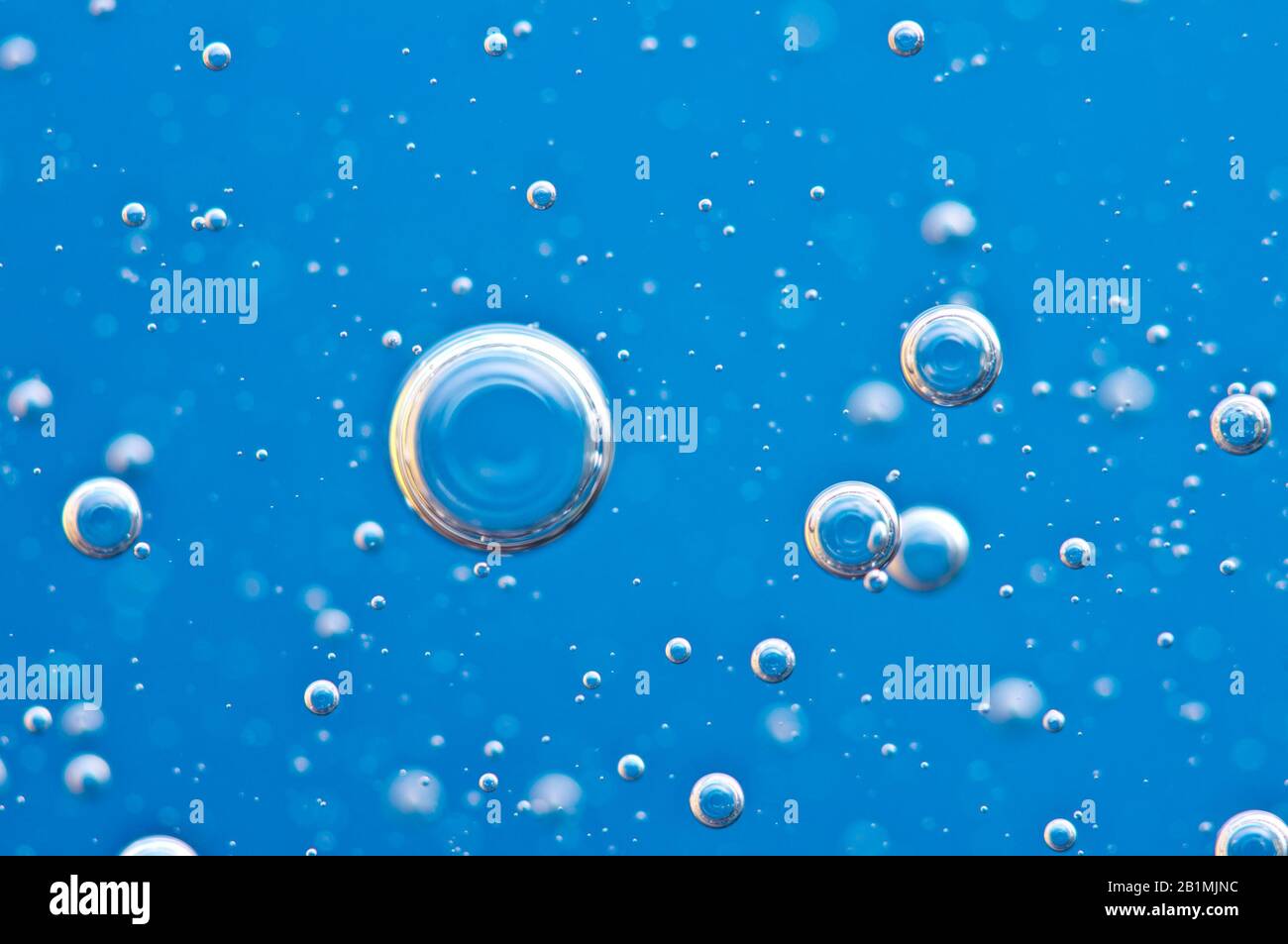 Bubbles of oxygen surging upward in blue water. Concept ecology ...