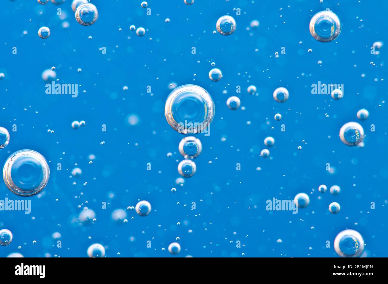 Bubbles of oxygen surging upward in blue water. Concept ecology ...