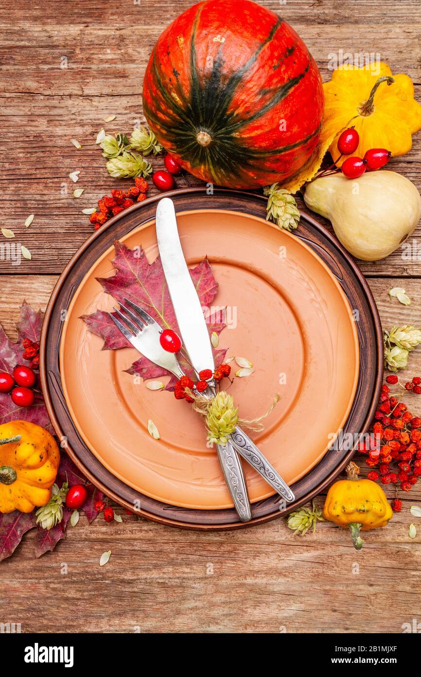 Autumn and Thanksgiving dinner place setting. Harvest of vegetables and ...