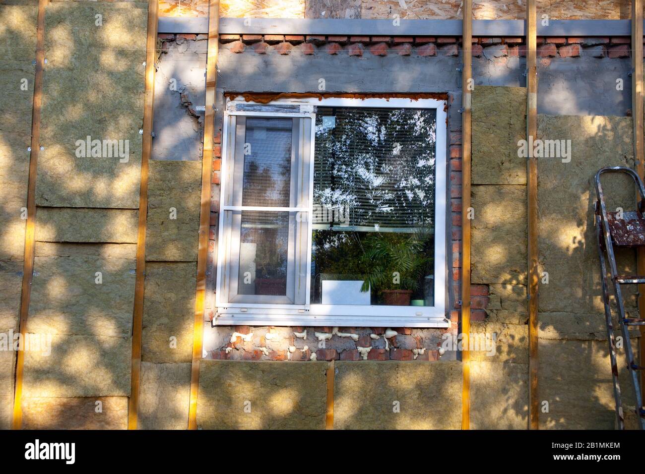 warming the walls of a stone house with a stone wool heater. Ecological ...