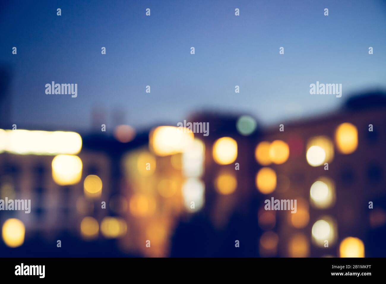 Blurry apartment block at dusk, urban city life, lights Stock Photo - Alamy