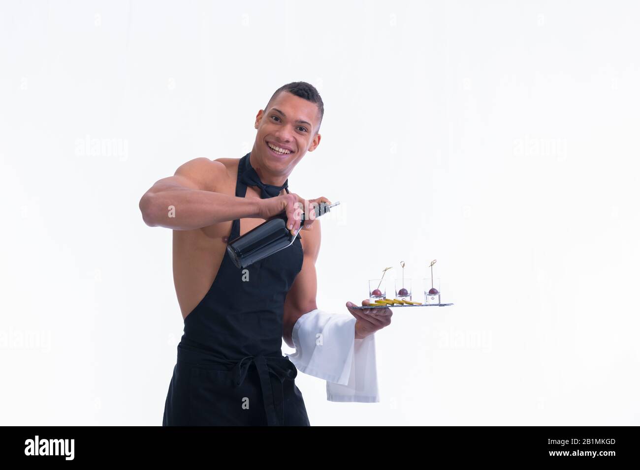 Shirtless waiter holding a plate smiles at the camera Stock Photo - Alamy