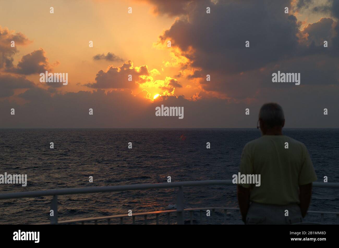 Tourist on a cruise ship watching sunset Stock Photo - Alamy