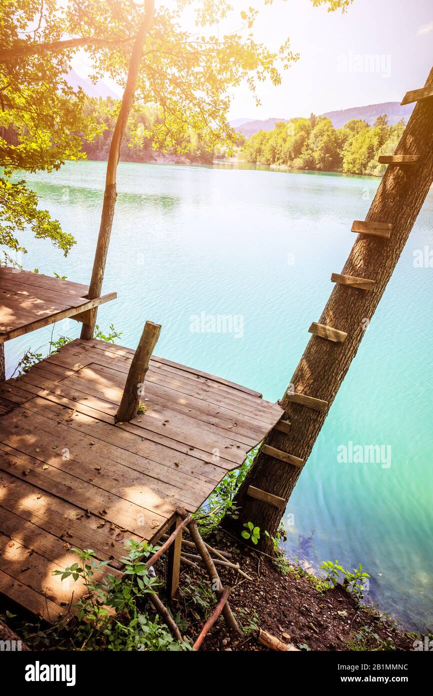 Treehouse wooden platform at a beautiful blue lake Stock Photo - Alamy