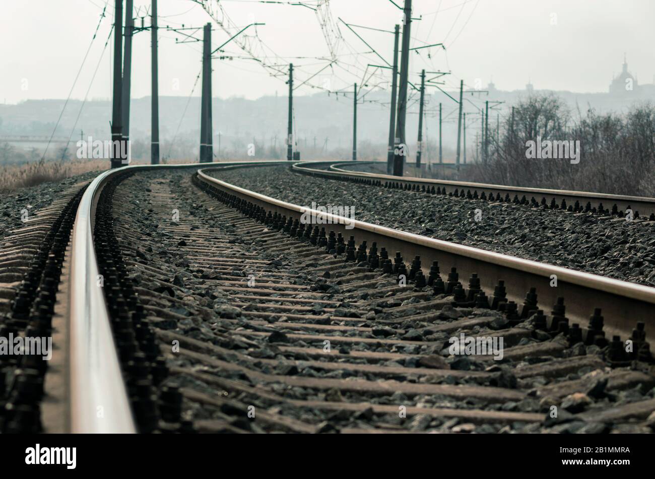 old railroad rails and poles with wires without a train without people ...