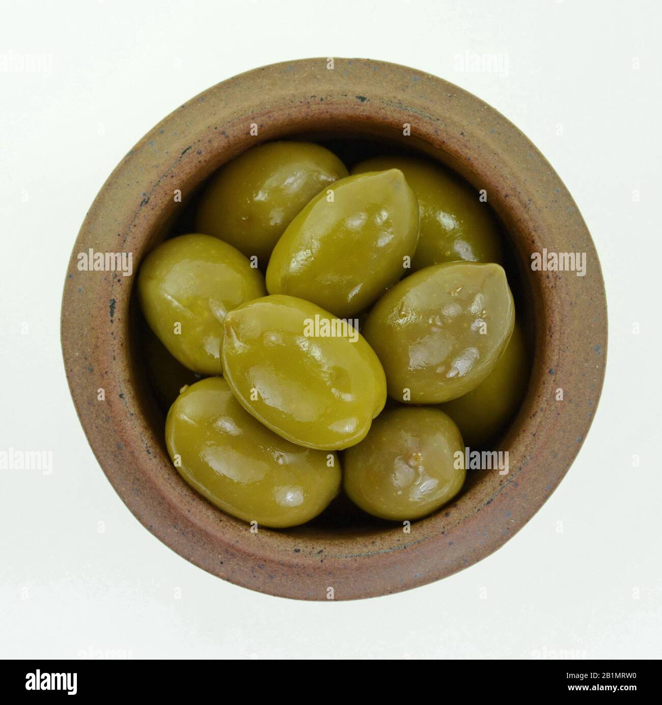 Olives in a clay bowl, isolated on white background Stock Photo - Alamy