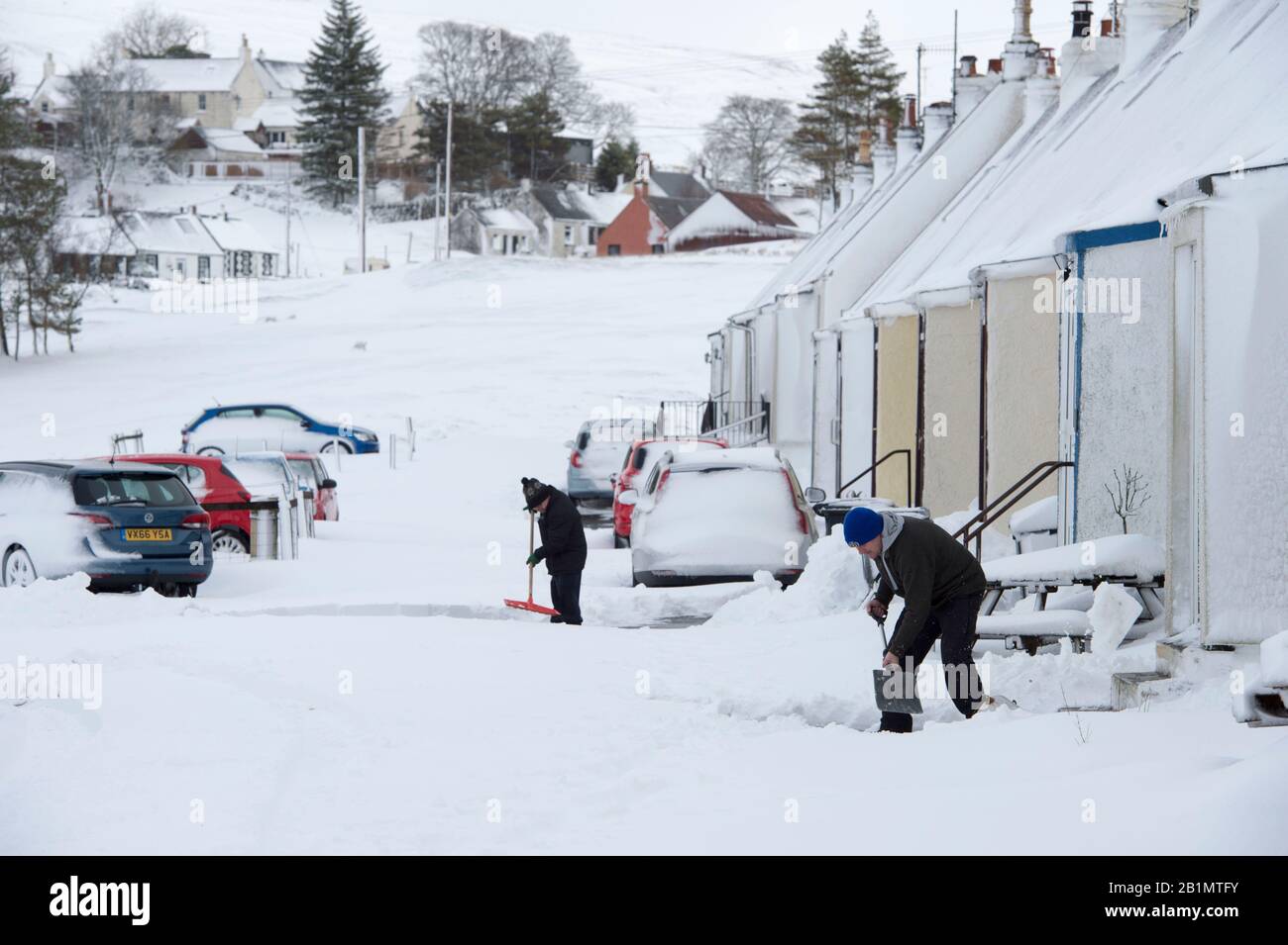 Weather: Local resident Peter Scott clears snow from his path outside ...