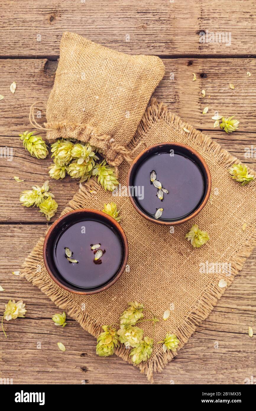 Cup of calming herbal tea with fresh wild hops. Brewery. Beer ...