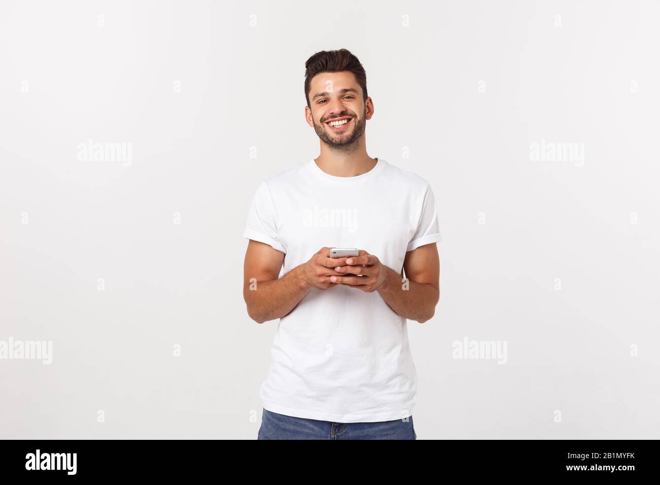 Charming handsome. Handsome young man in casual wear while standing ...