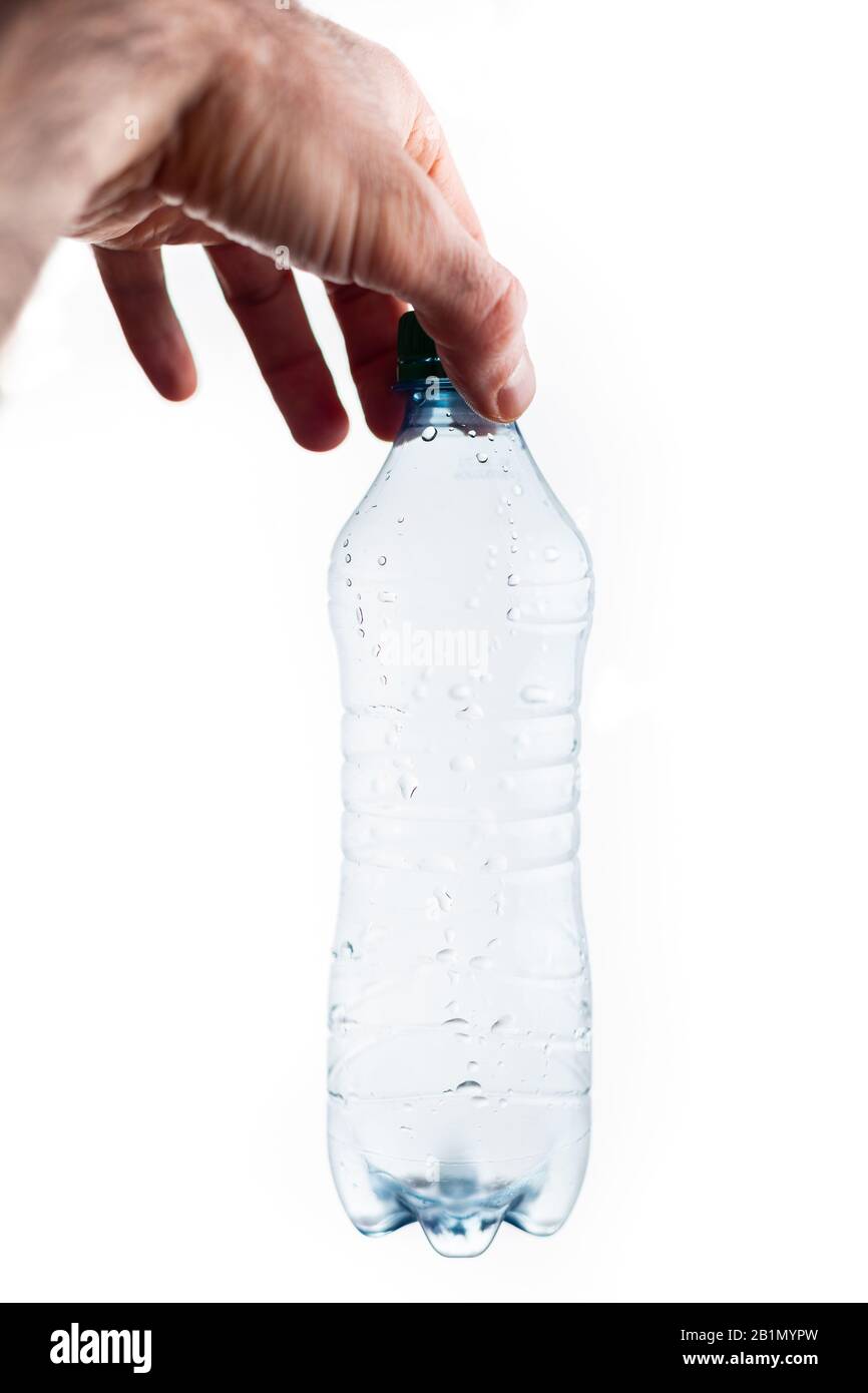Man holding a used plastic bottle in hand. Isolated on white background ...