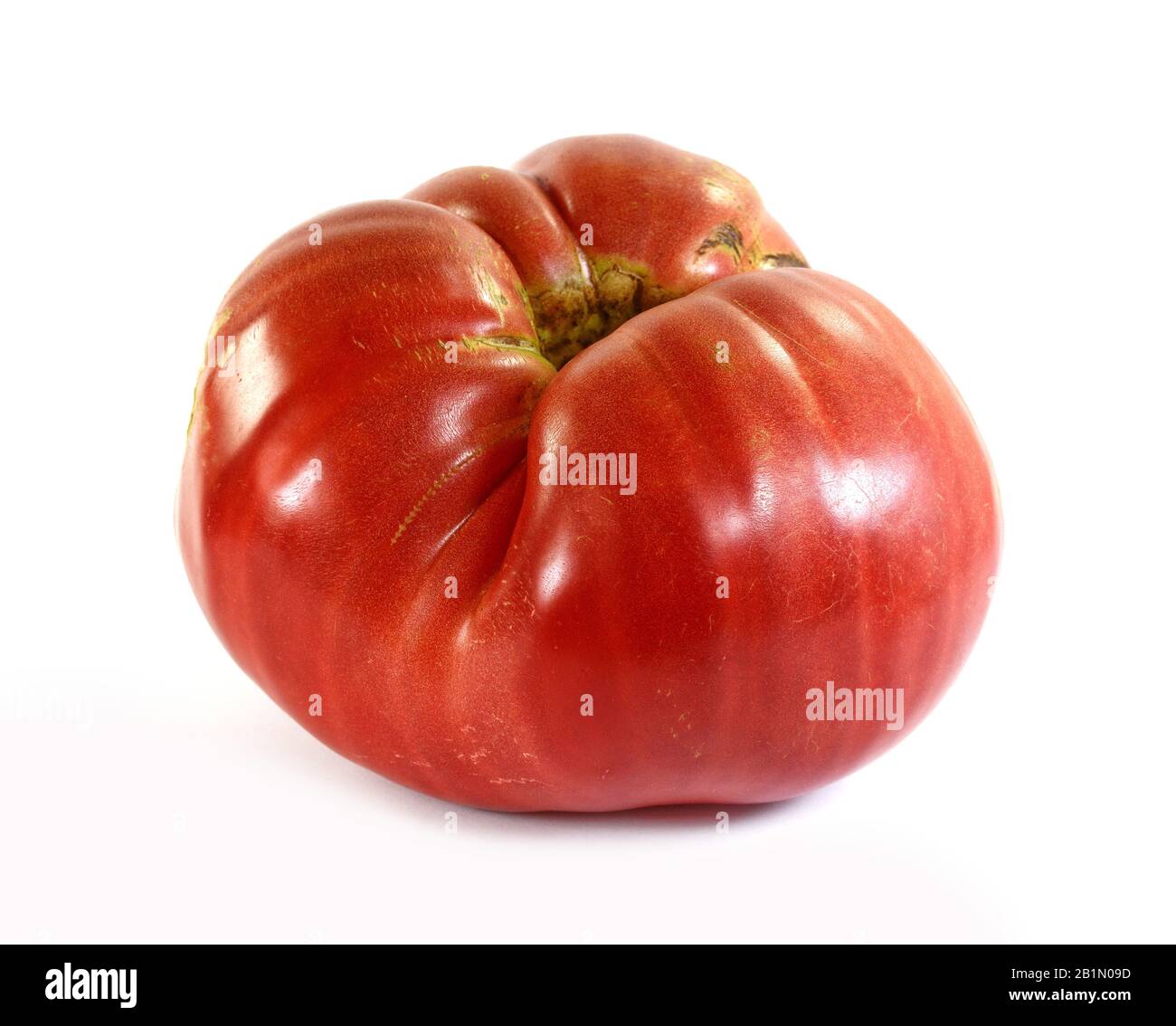 Strange shape fresh tomato isolated on white background Stock Photo - Alamy