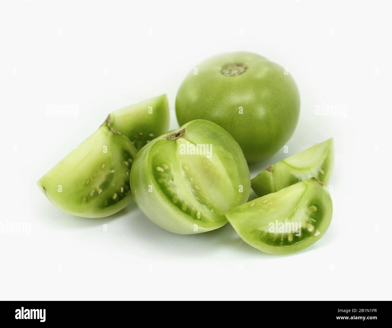 green tomato on white background. Green tomato slices Stock Photo - Alamy
