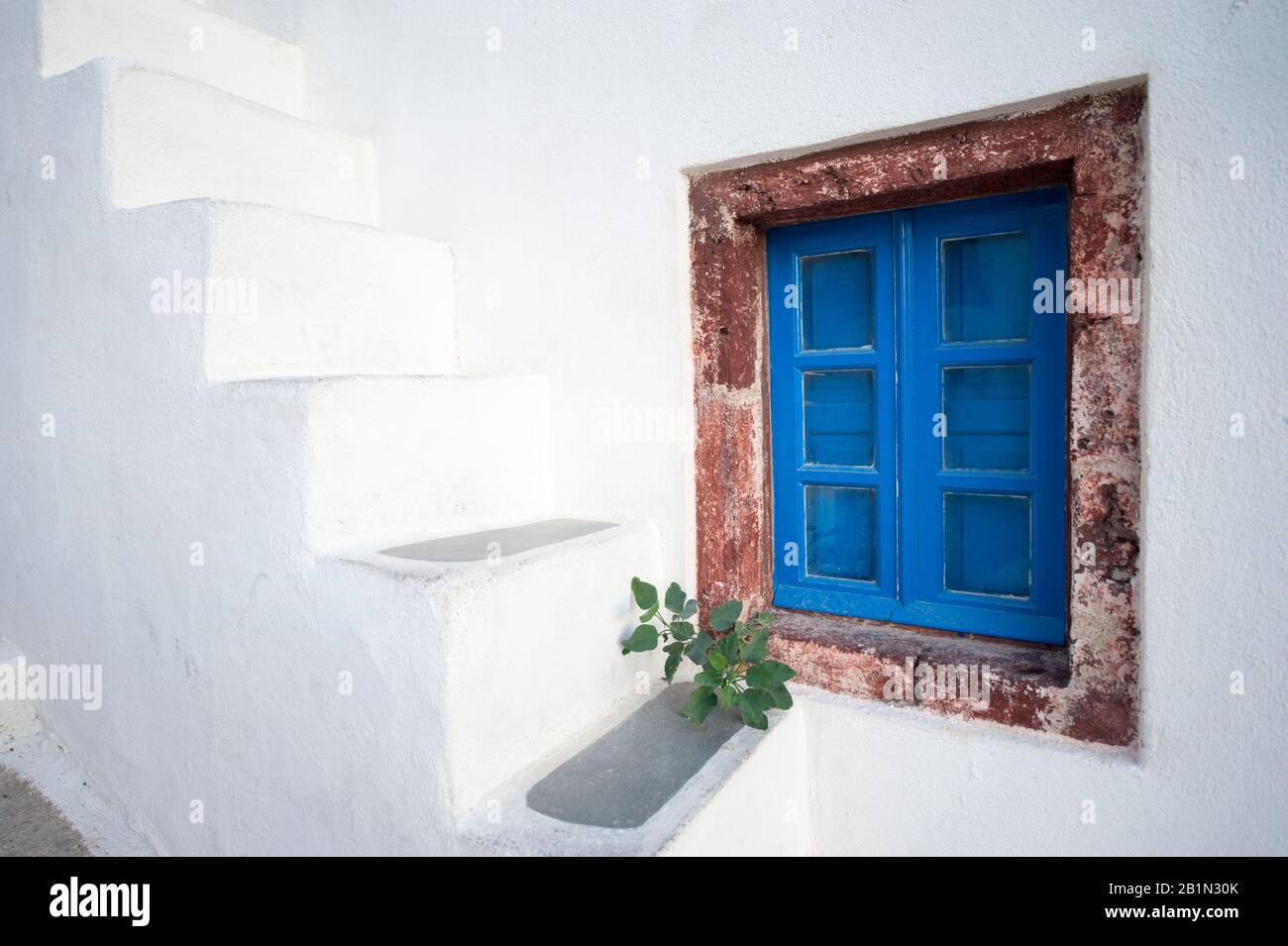 Quaint Mediterranean blue window with Greek whitewashed steps on the ...