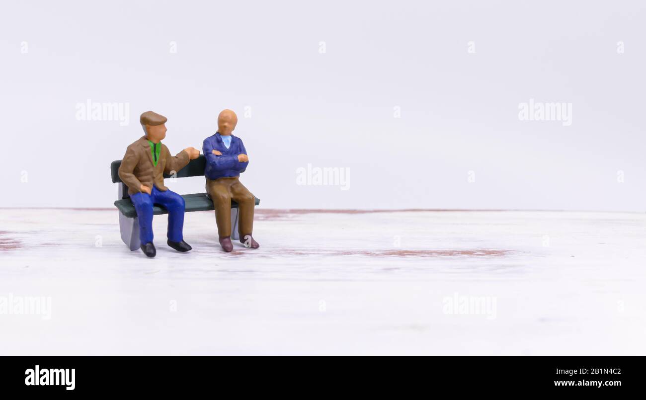 Two men talking on park bench hi-res stock photography and images - Alamy