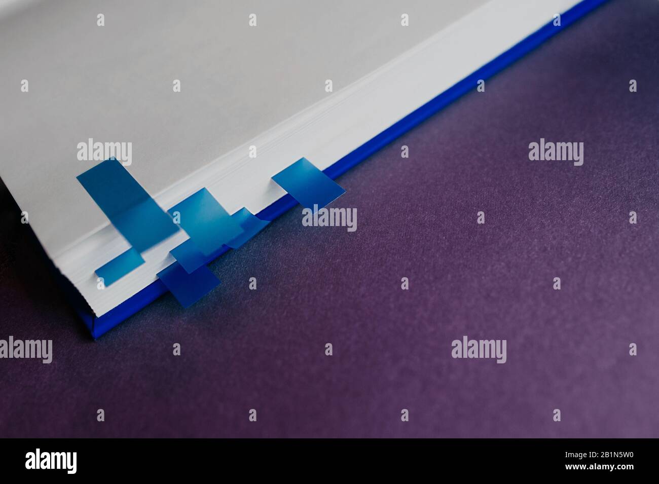 Blue thick hardcover book with white sheets and blue sticky bookmarks ...