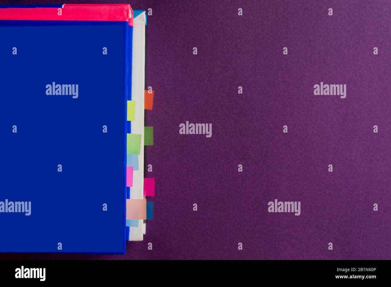 Blue thick hardcover book with white sheets and blue sticky bookmarks ...