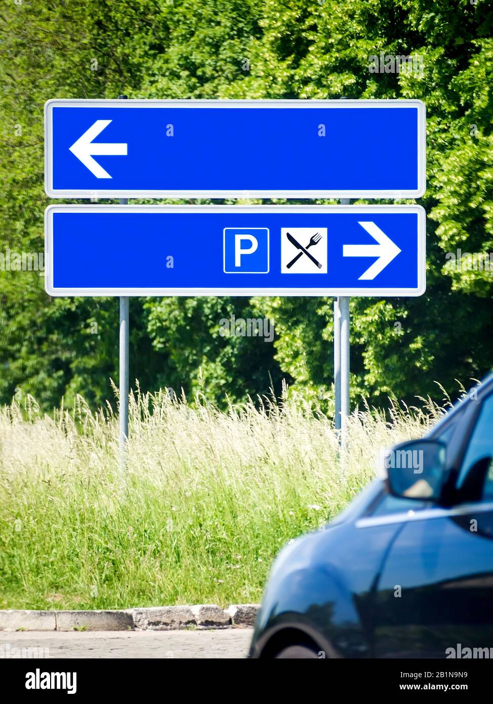 blue direction sign at a junction, Germany, Bavaria Stock Photo - Alamy