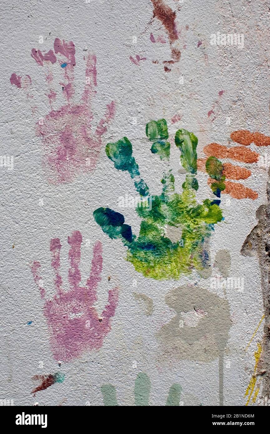 Colorful handprints on a wall Stock Photo - Alamy