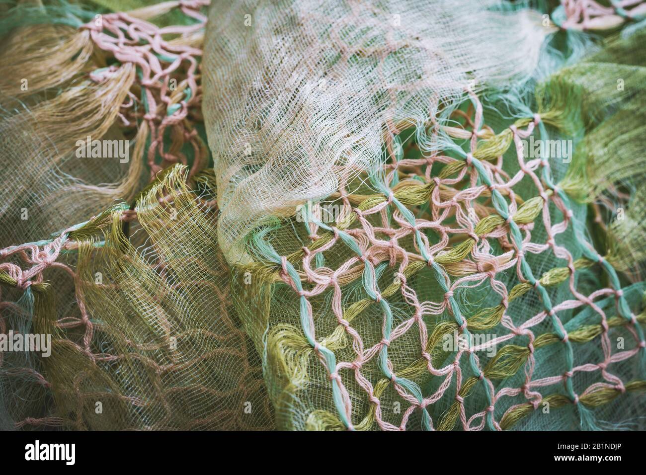 Macrame knots decorating a green crumpled shawl Stock Photo - Alamy