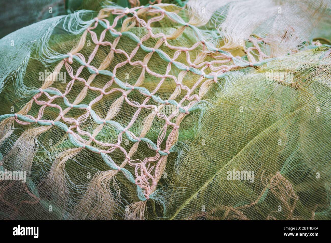 Macrame knots decorating a green crumpled shawl Stock Photo - Alamy