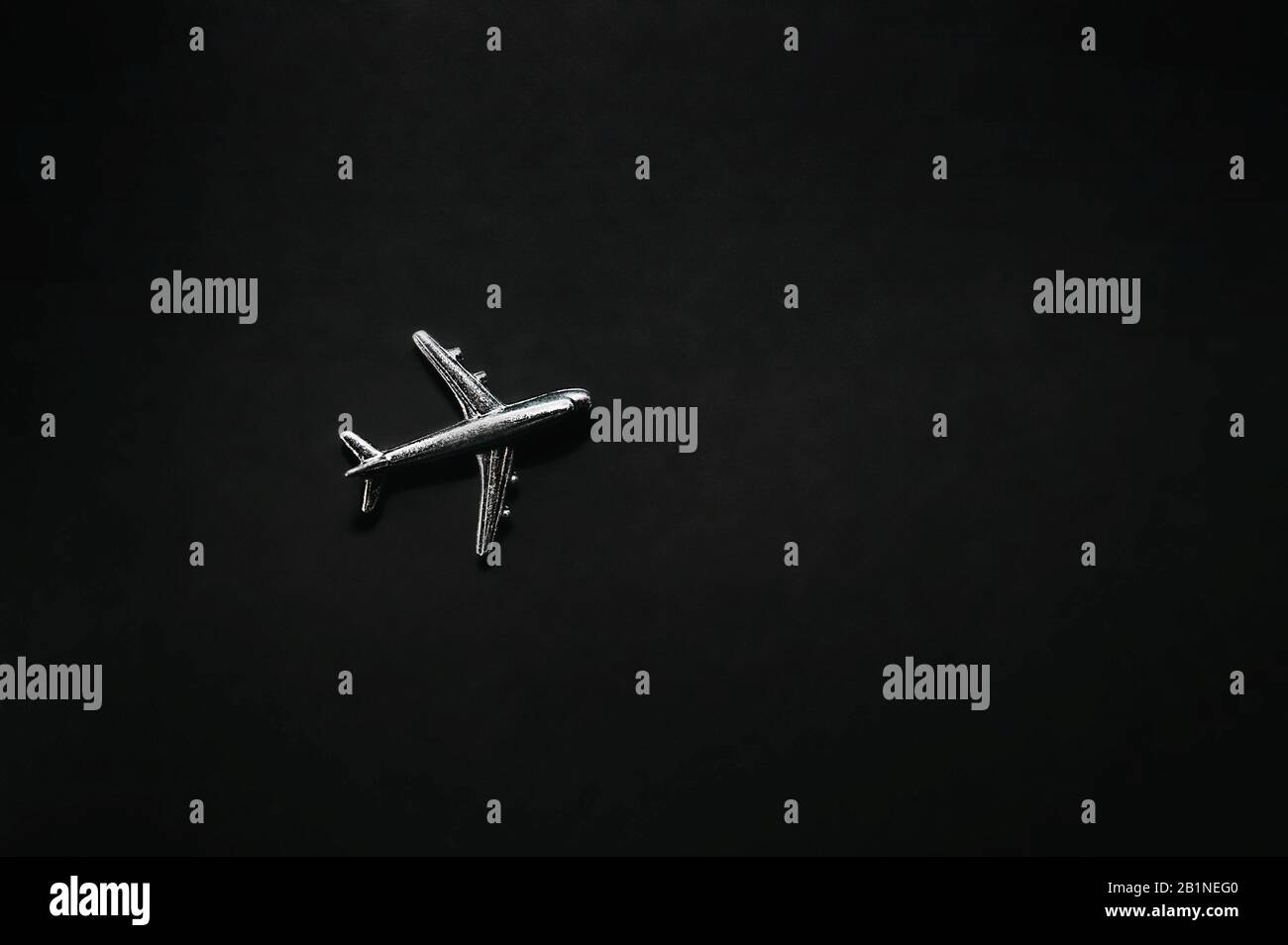 metal figure of an airplane on a clean black background Stock Photo - Alamy