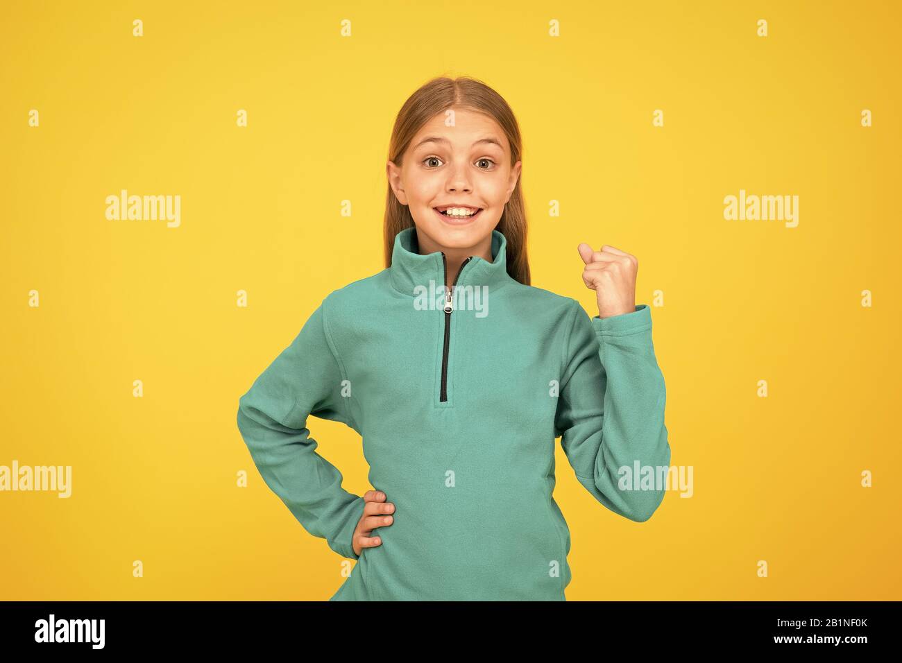 Happiness is key to success. Happy girl keep fist raised with success ...