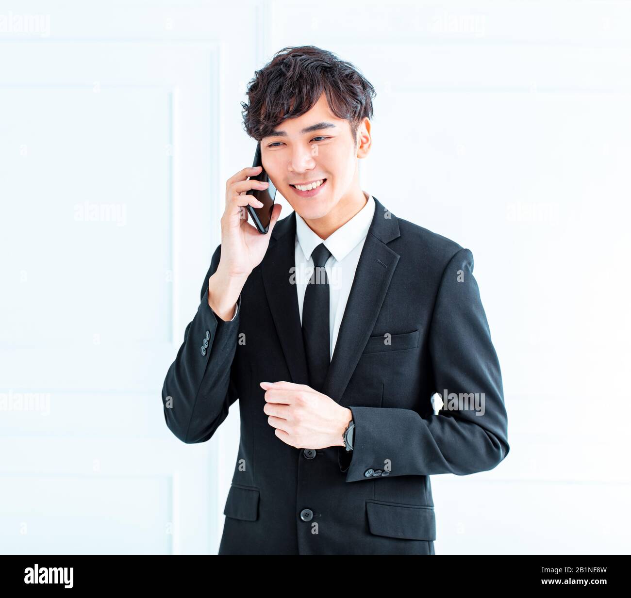 Smiling young man smartphone making hi-res stock photography and images ...
