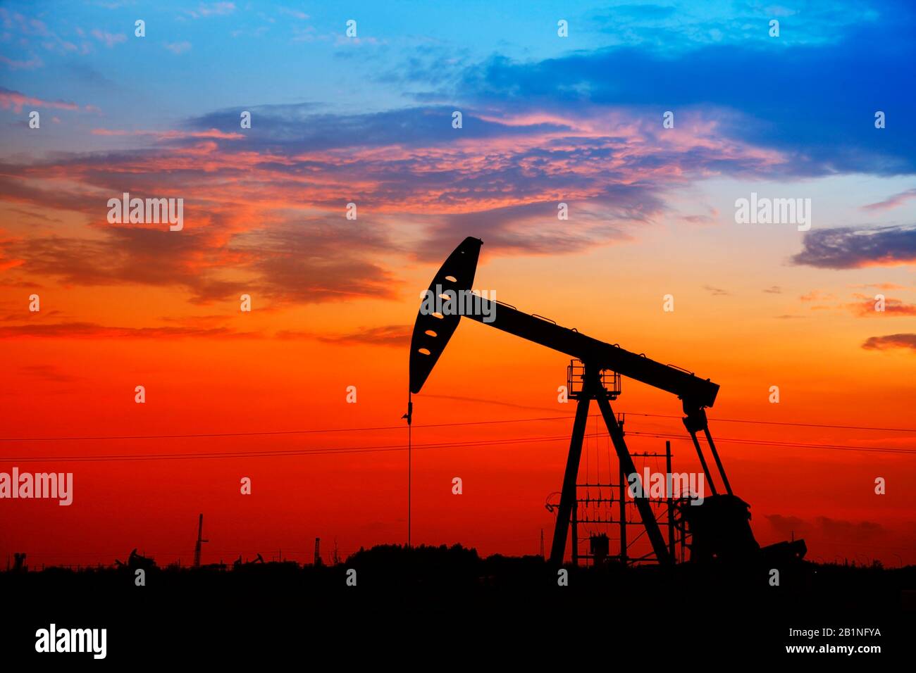 Oil field scene, the evening of beam pumping unit in silhouette Stock ...