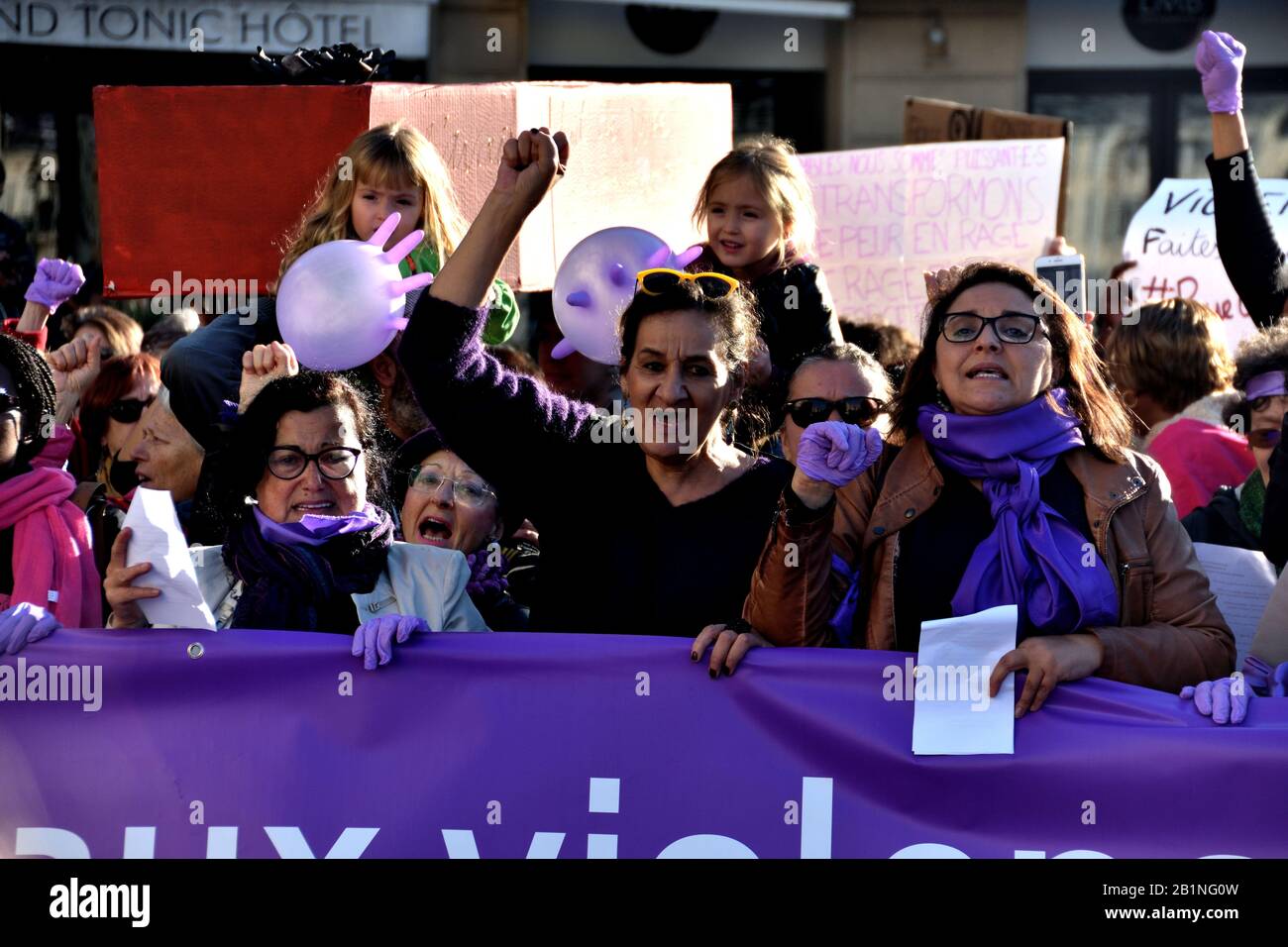 Women shout slogans while holding a banner during the demonstration ...