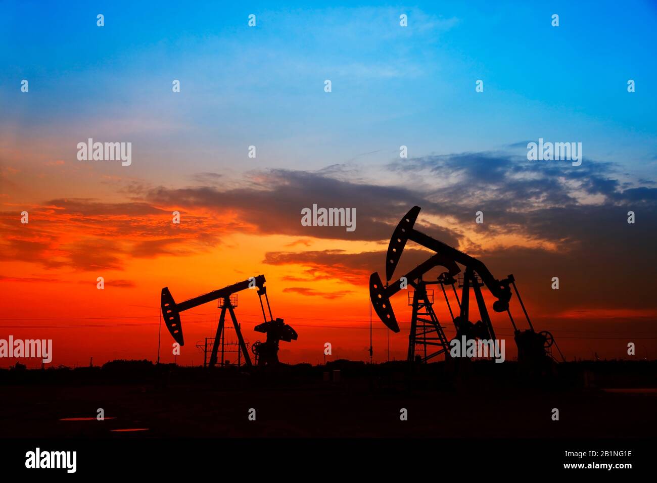 Oil field scene, the evening of beam pumping unit in silhouette Stock ...