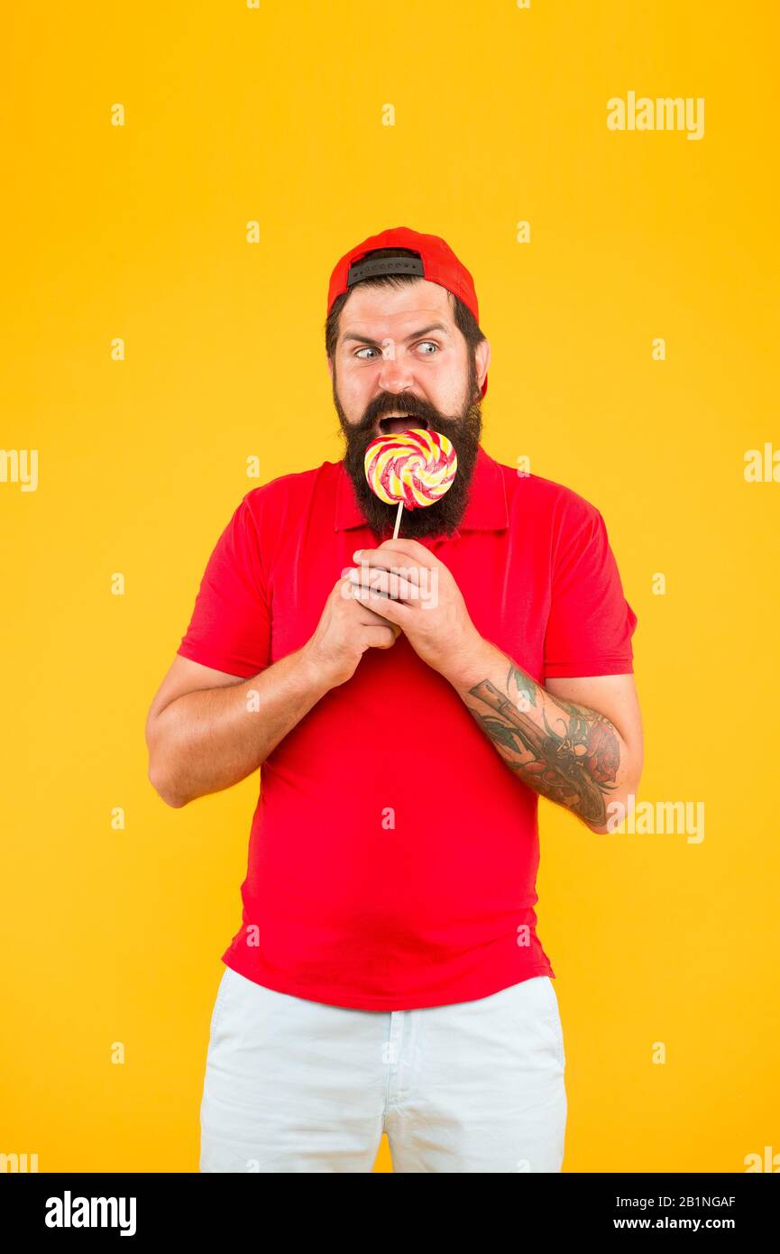 candy shop. Sweet boy. Taste of childhood. Happy eating sweets. Man eat ...