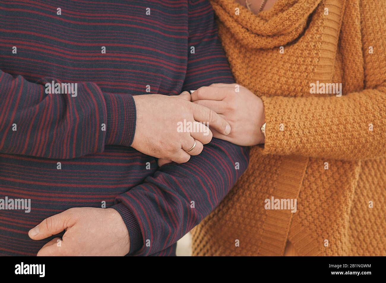 light-skinned heterosexual couple in knitted clothes without people ...
