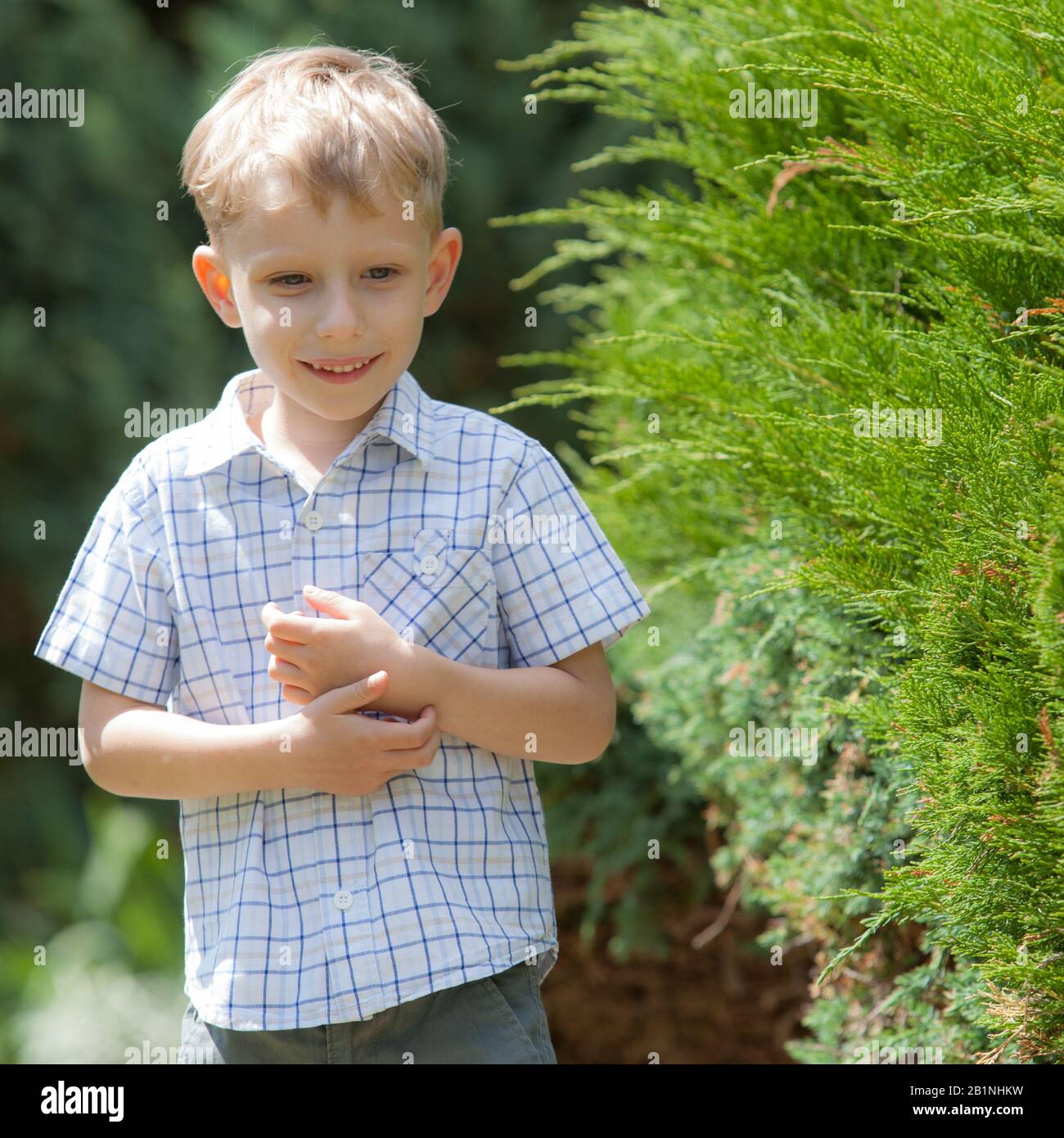 Cute fair-haired boy is playing outside Stock Photo - Alamy