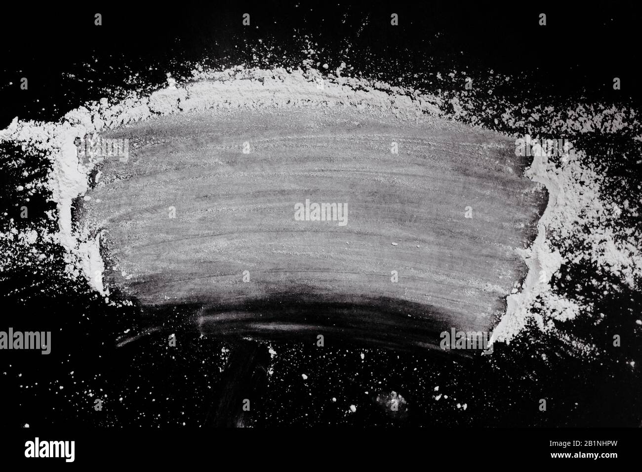 white ground smeared white powder on a black clean background, place ...