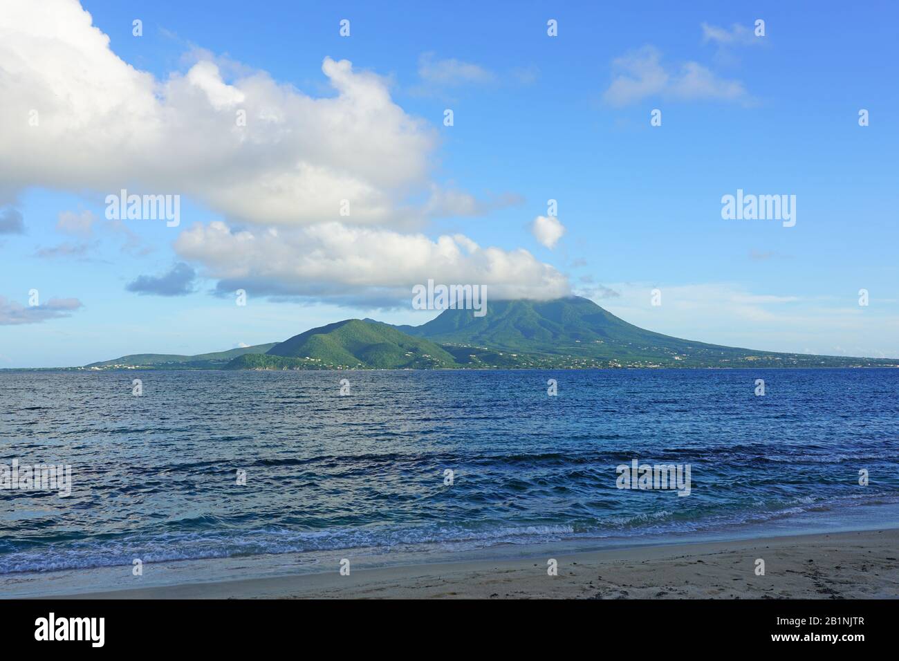 Day view of the Nevis Peak volcano across the water from St Kitts Stock ...