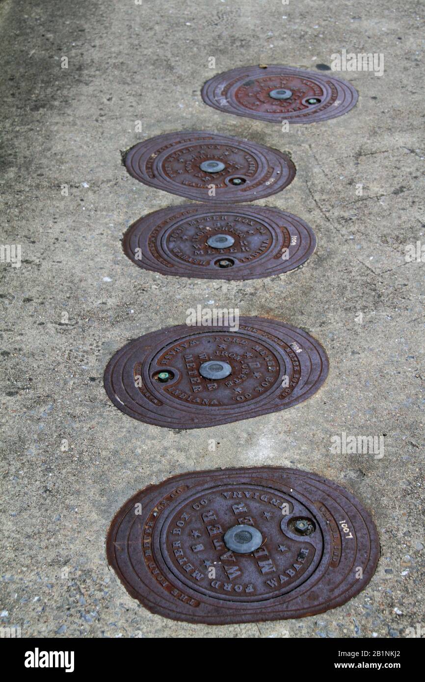 Meter pit iron covers on U.S. city street Stock Photo - Alamy