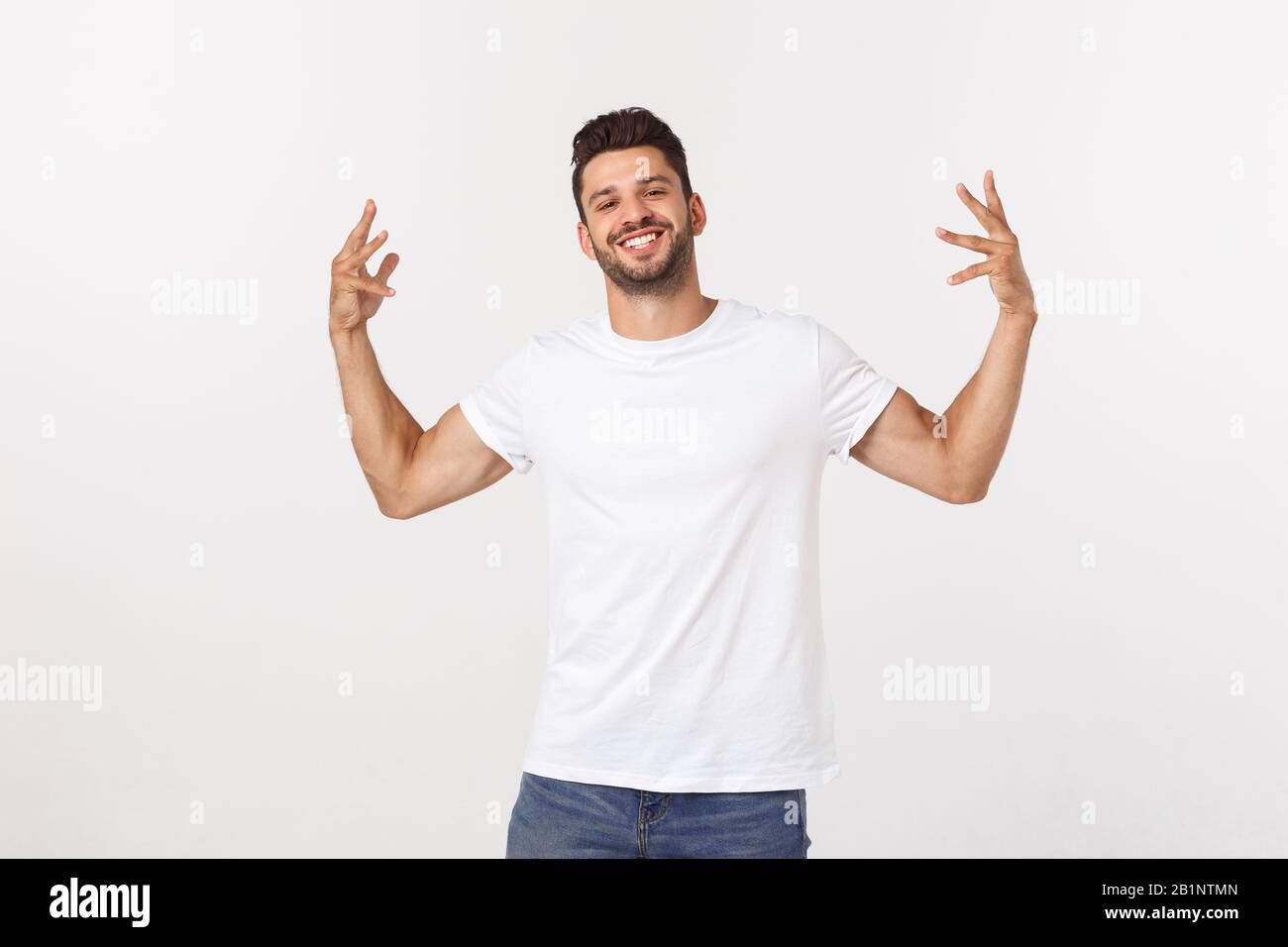 Charming handsome. Handsome young man in casual wear while standing ...